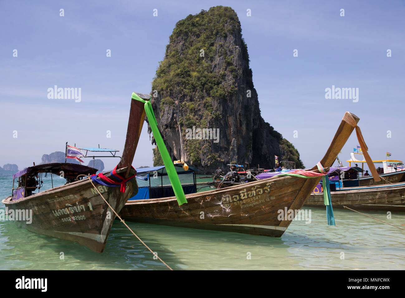 Long boats moored at southern Thailand's Railey beach Stock Photo - Alamy