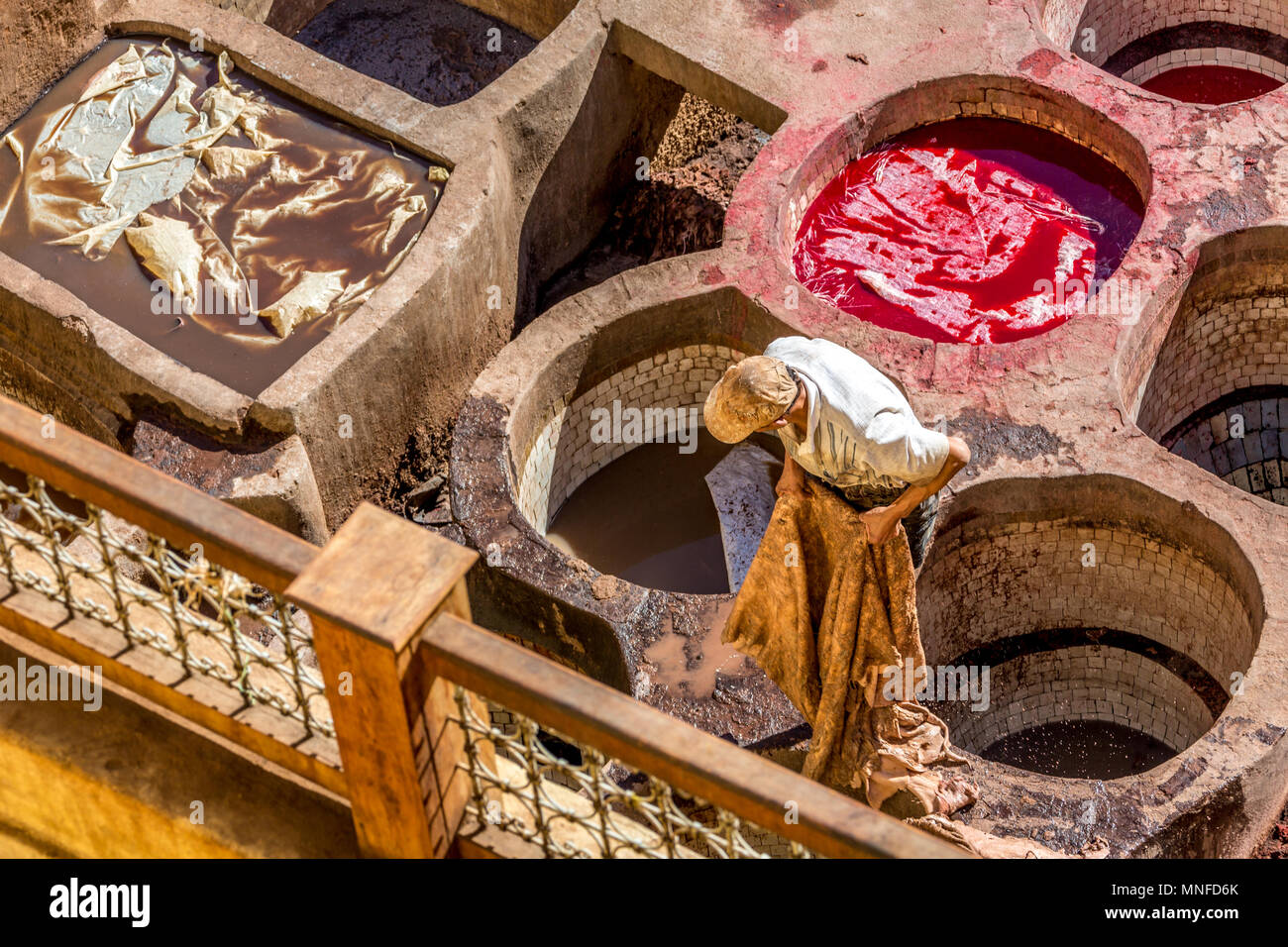 Workers using the hot, old and difficult traditional methods of tanning ...