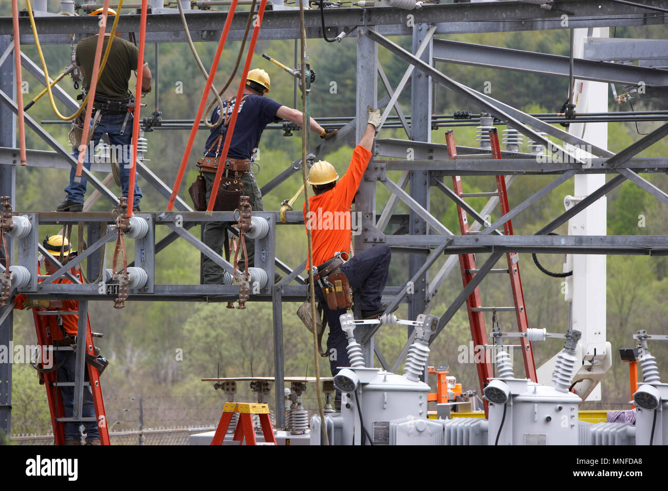 Utility workmen installing updated components to a "city gate ...