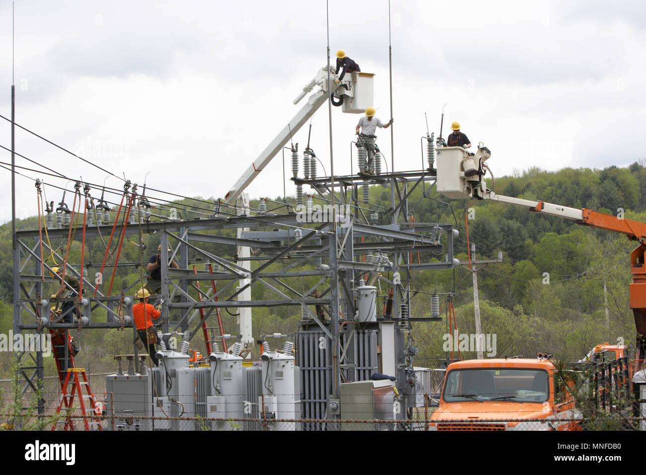 Utility workmen installing updated components to a "city gate ...