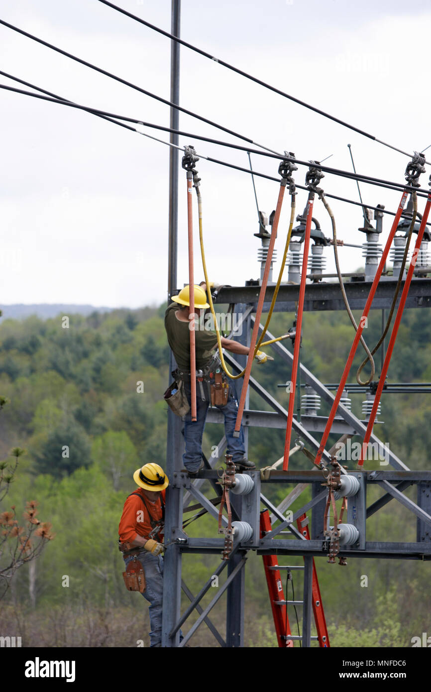 Utility workmen installing updated components to a "city gate ...