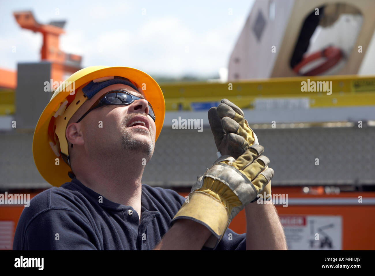 Electrical Utility workman looks at work in progress on an ...