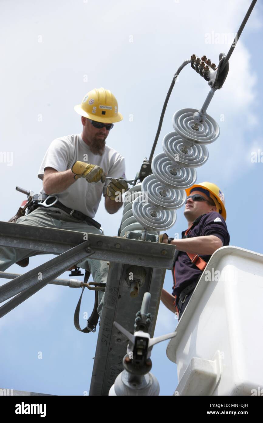 Utility workmen installing updated components to a "city gate ...