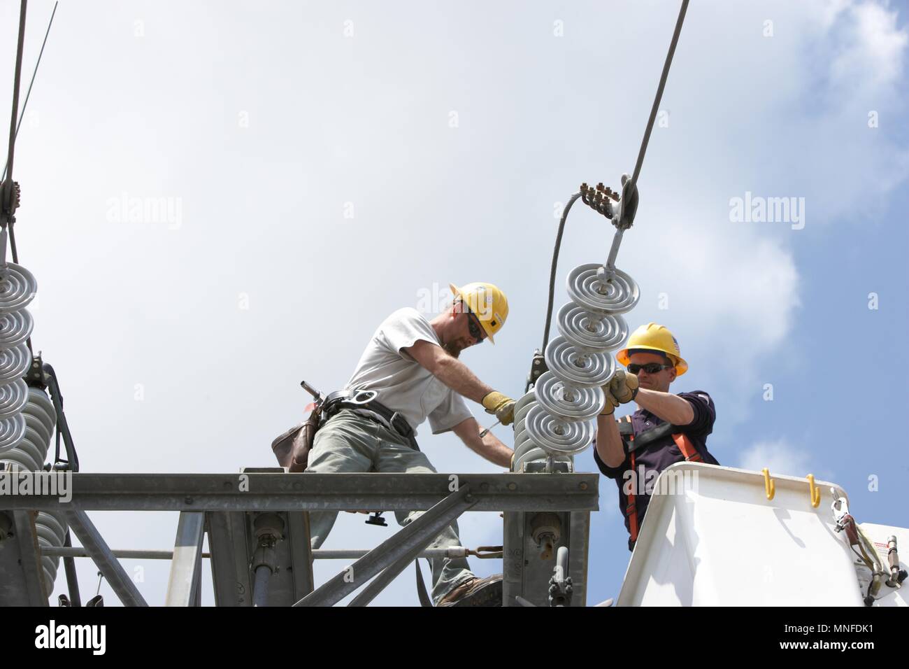Utility workmen installing updated components to a "city gate ...