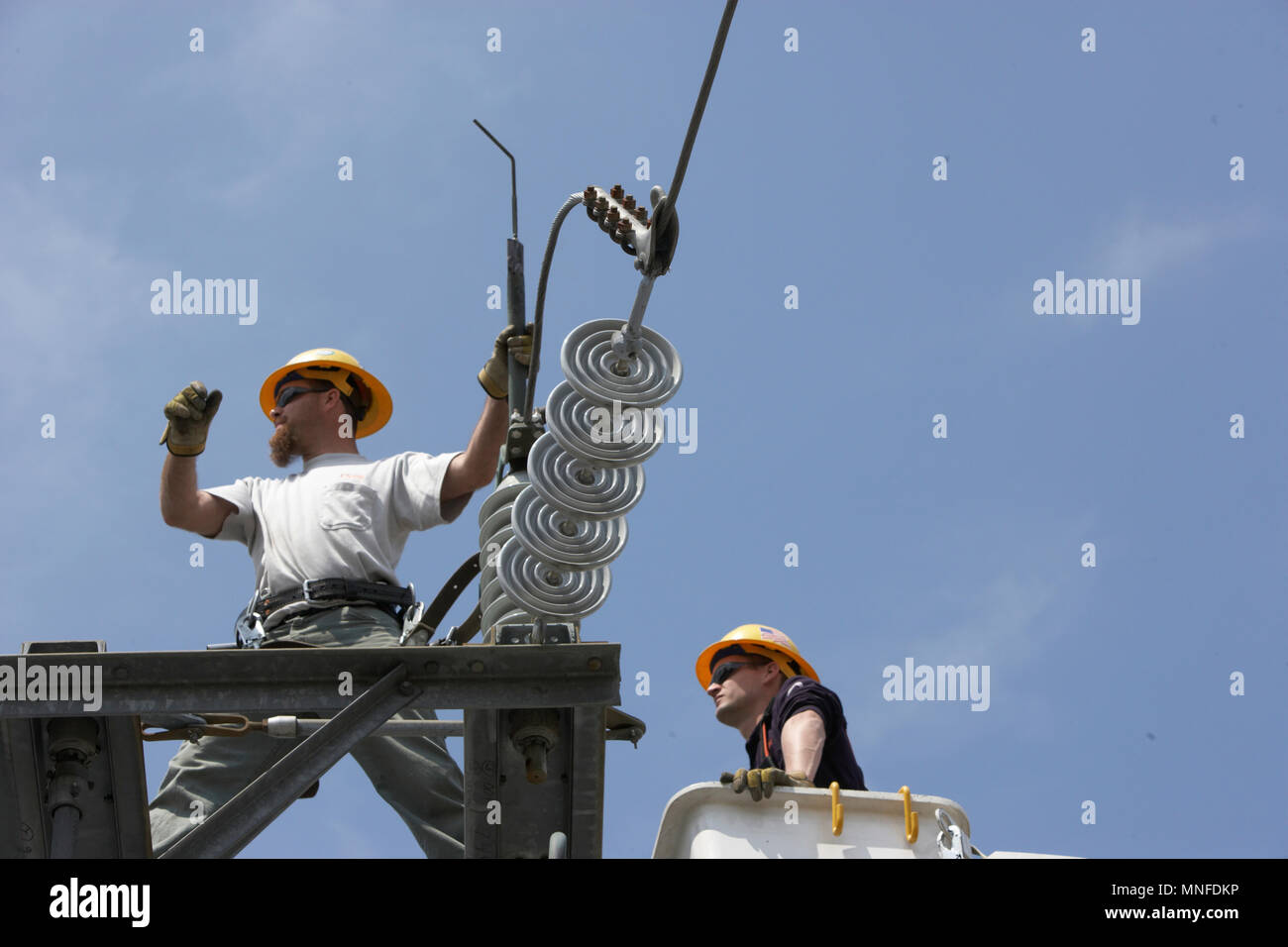 Utility workman installing updated components to a "city gate ...