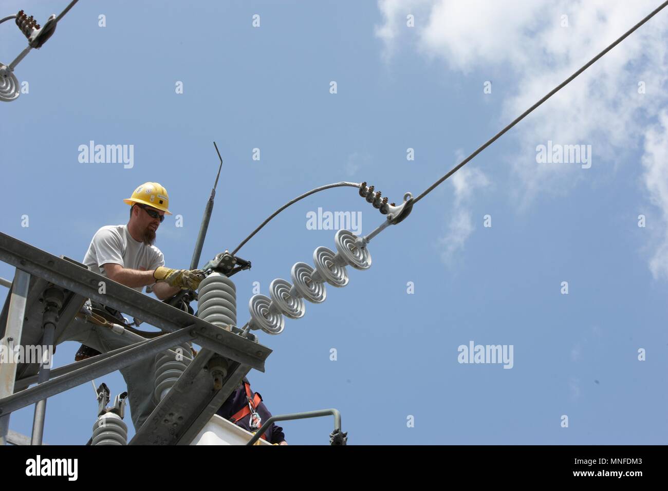 Utility workman installing updated components to a "city gate ...
