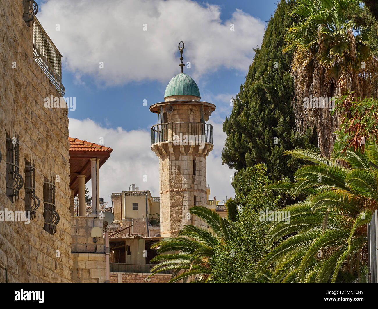 Stone walls of the old medina are covered with green plants, the ...