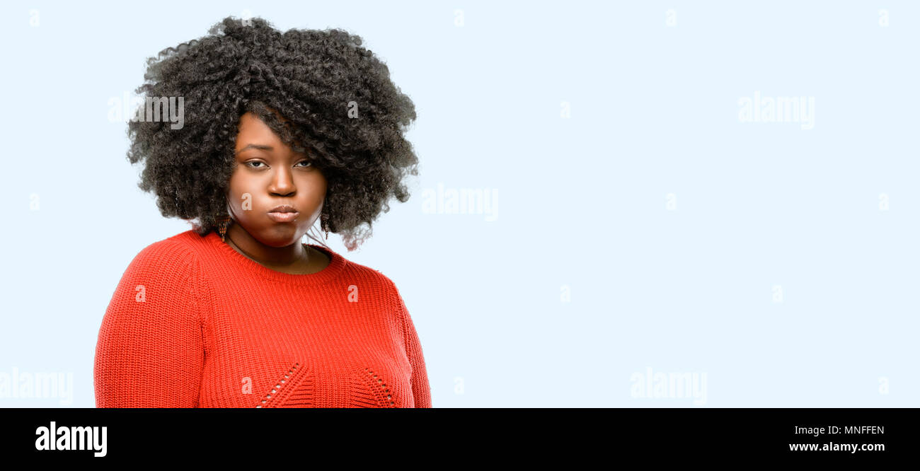 Beautiful african woman puffing out cheeks, having fun making funny ...