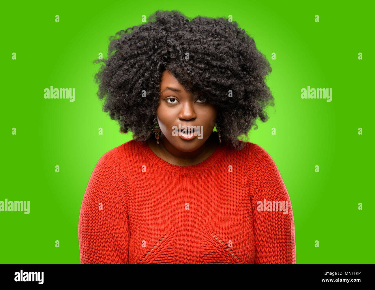 Beautiful african woman scared in shock, expressing panic and fear ...