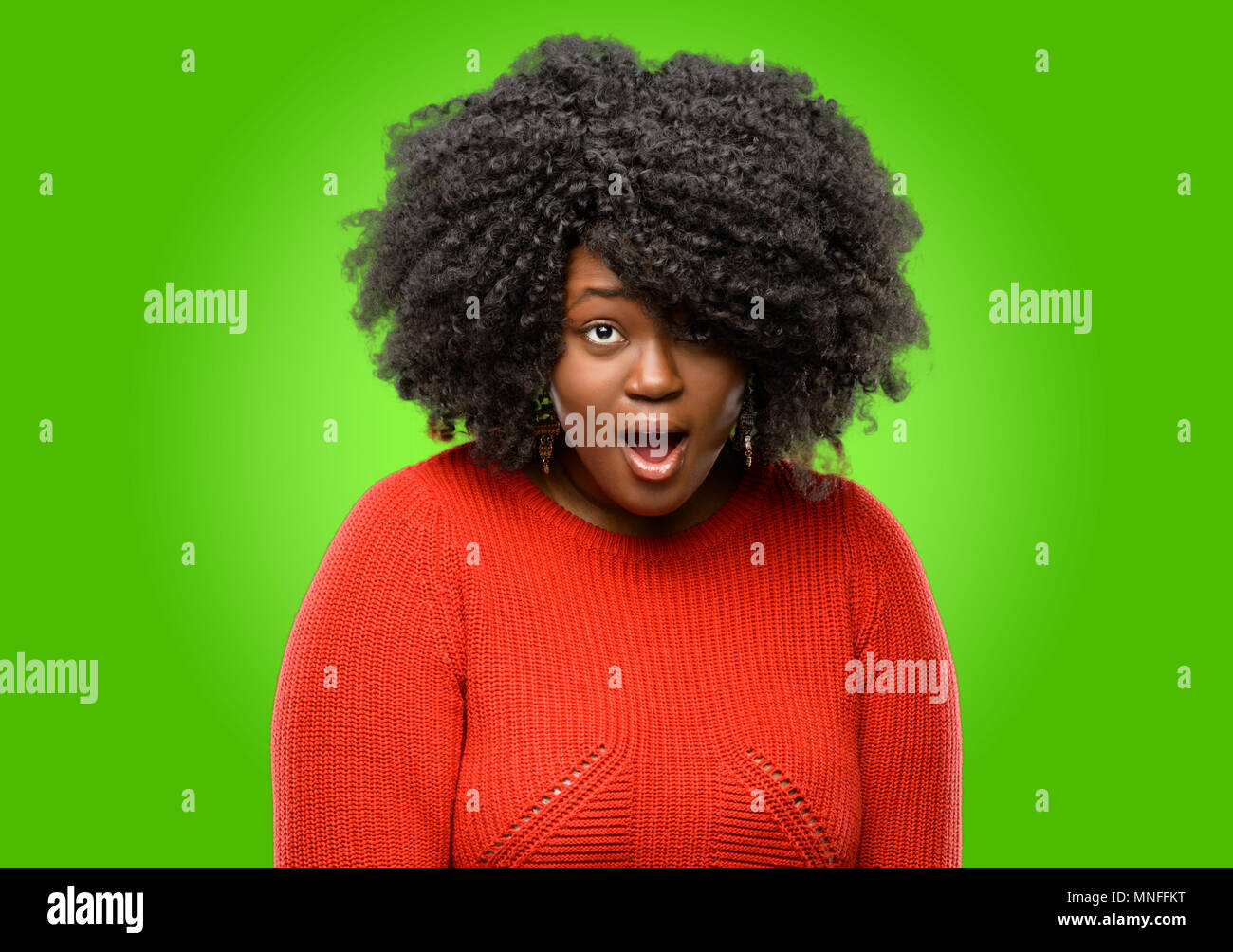 Beautiful african woman scared in shock, expressing panic and fear ...