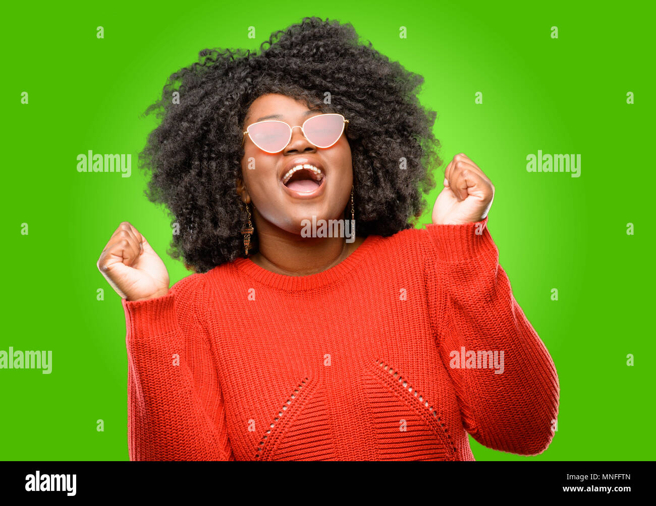 Beautiful african woman happy and excited expressing winning gesture ...