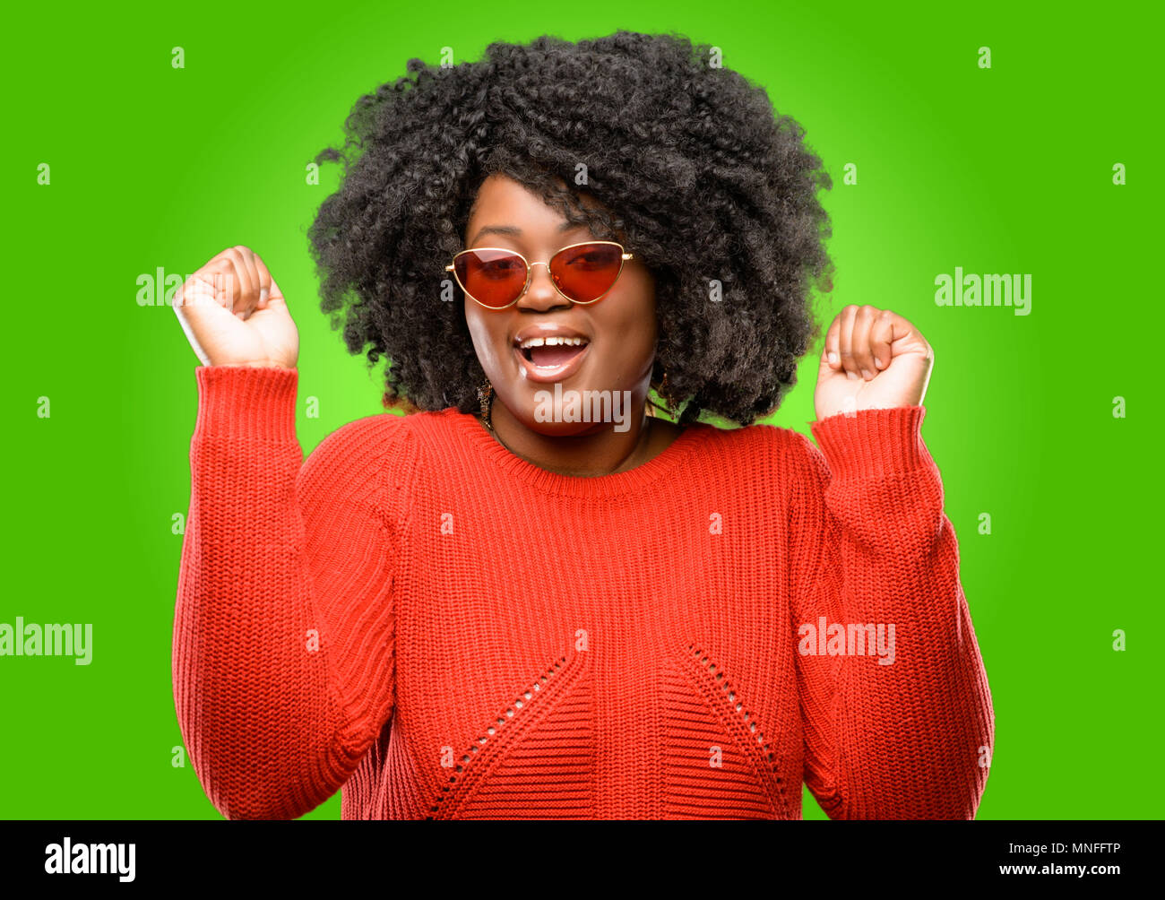 Beautiful african woman happy and excited expressing winning gesture ...