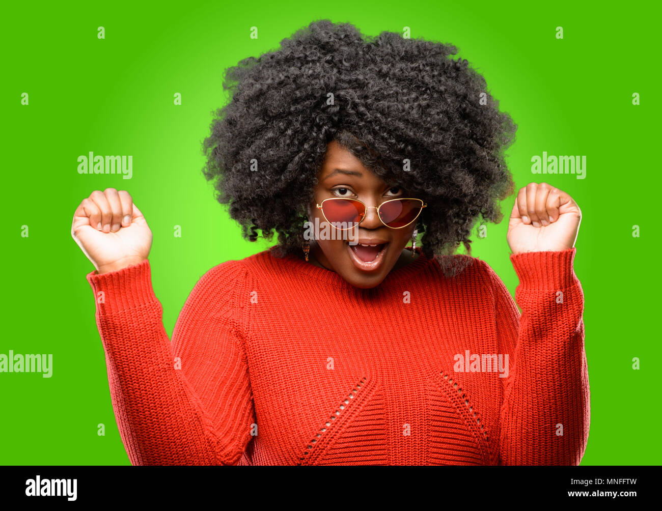 Beautiful african woman happy and excited expressing winning gesture ...