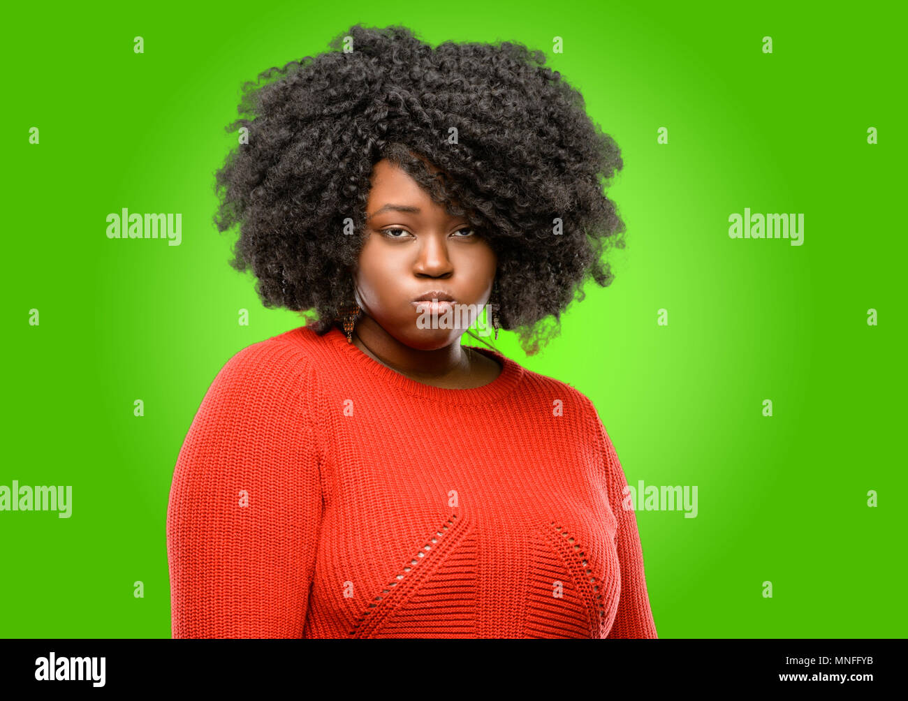 Beautiful african woman puffing out cheeks, having fun making funny ...