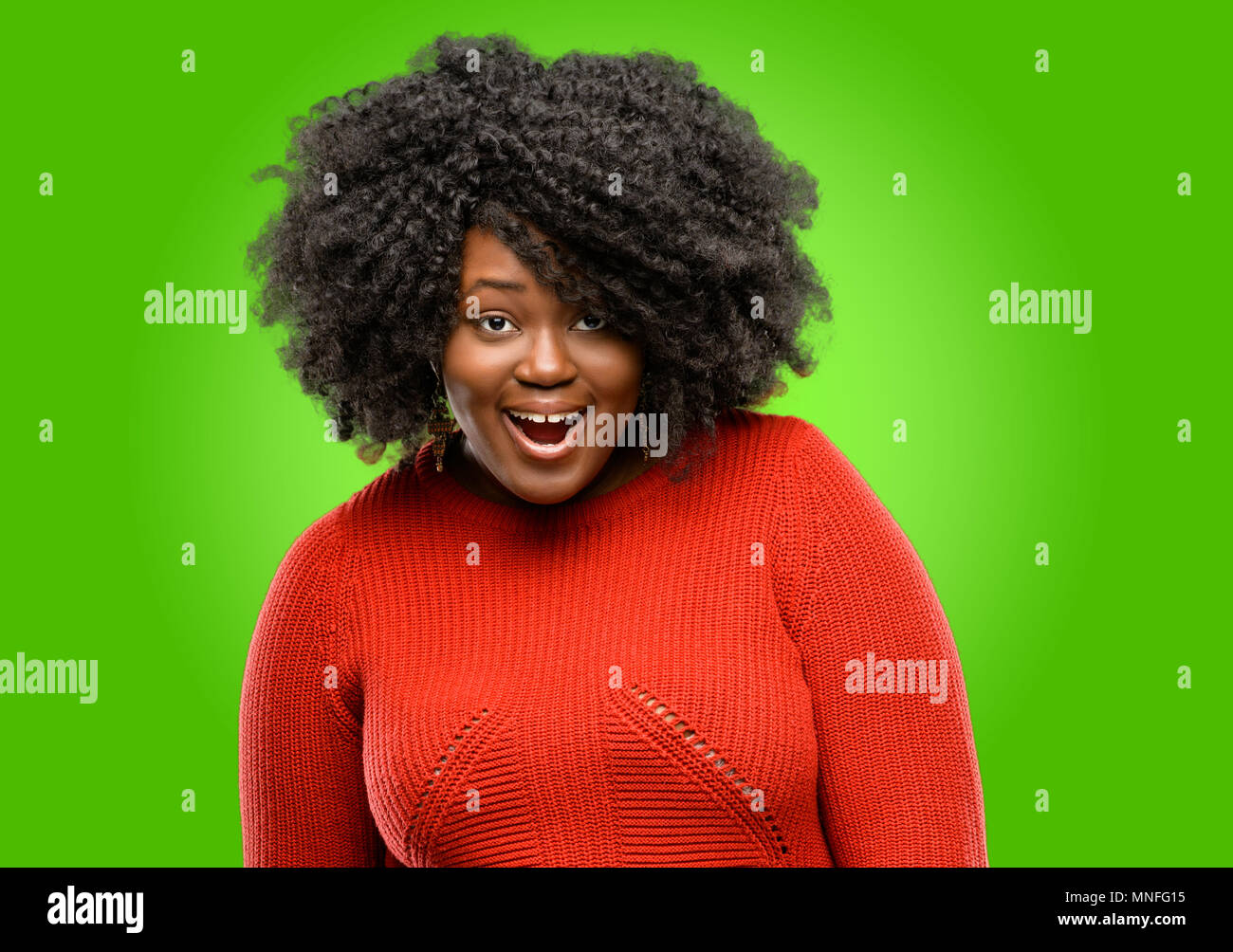 Beautiful african woman scared and surprised cheering expressing wow ...