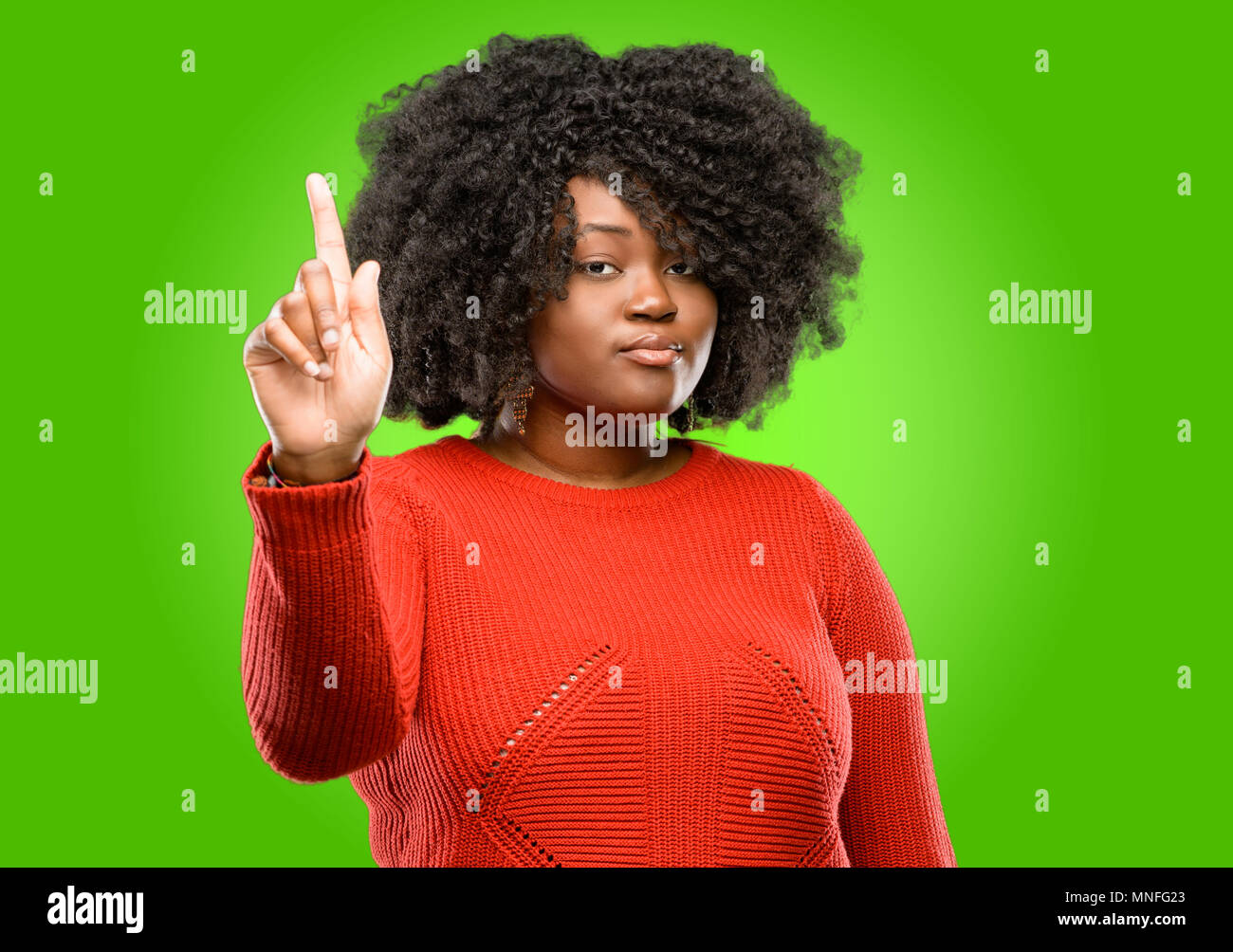 Beautiful african woman raising his finger, the number one Stock Photo ...