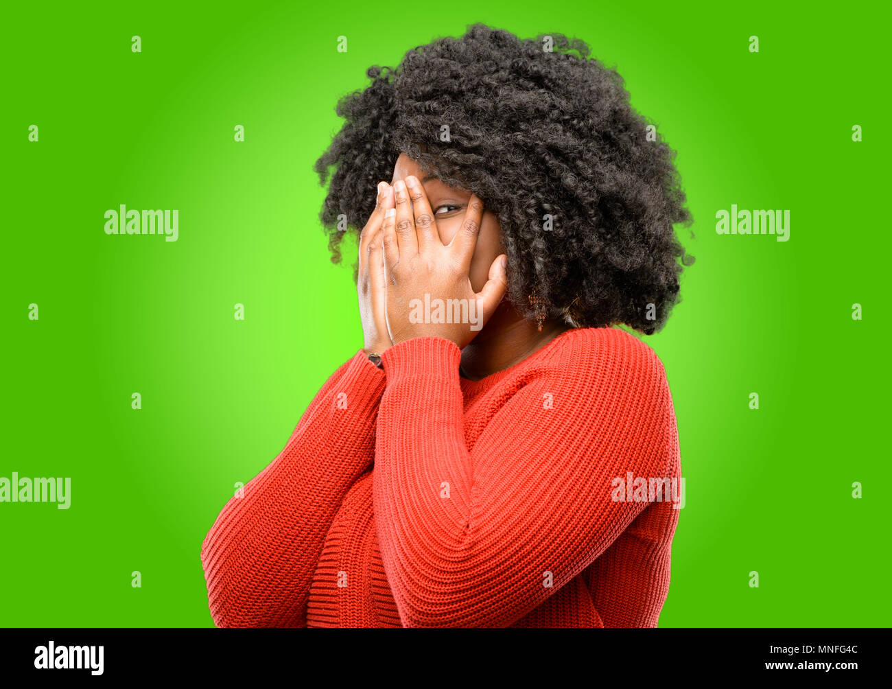 Beautiful african woman smiling having shy look peeking through her ...