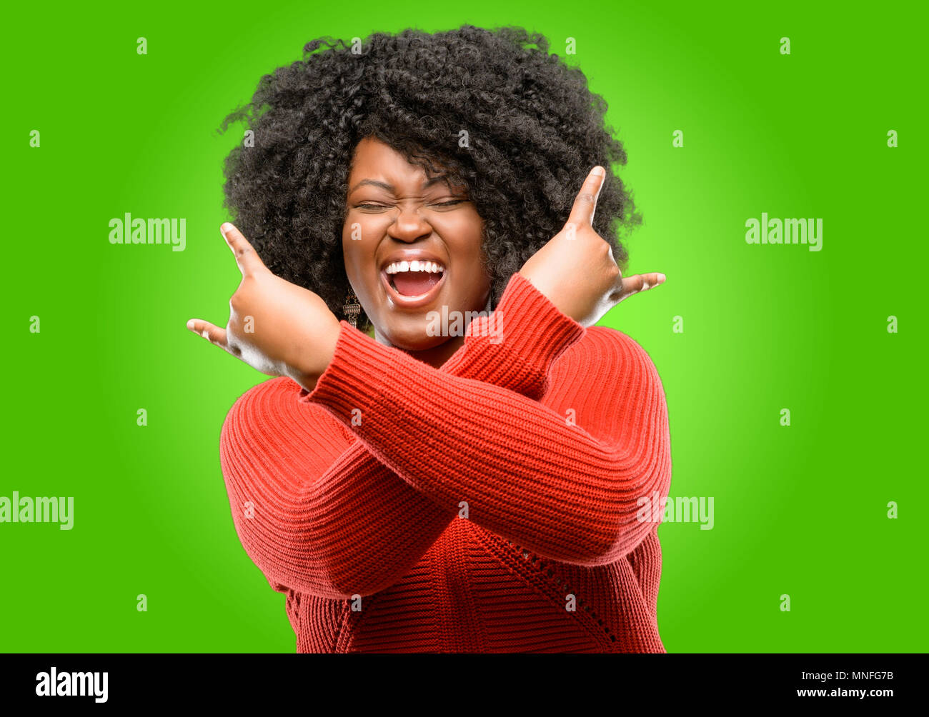 Beautiful african woman making rock symbol with hands, shouting and ...