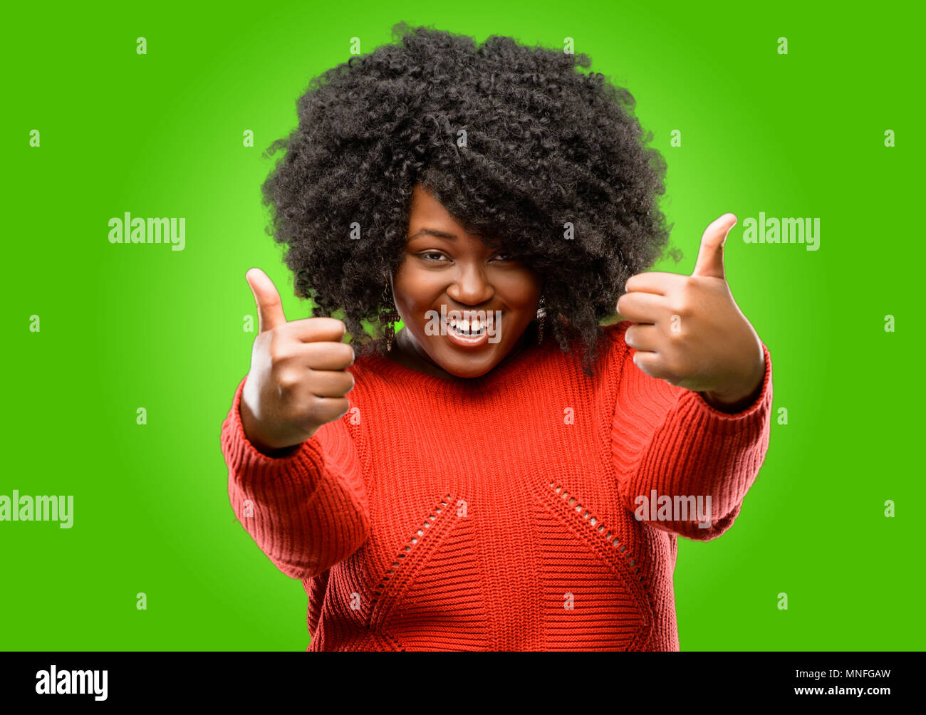 Beautiful african woman smiling broadly showing thumbs up gesture to ...