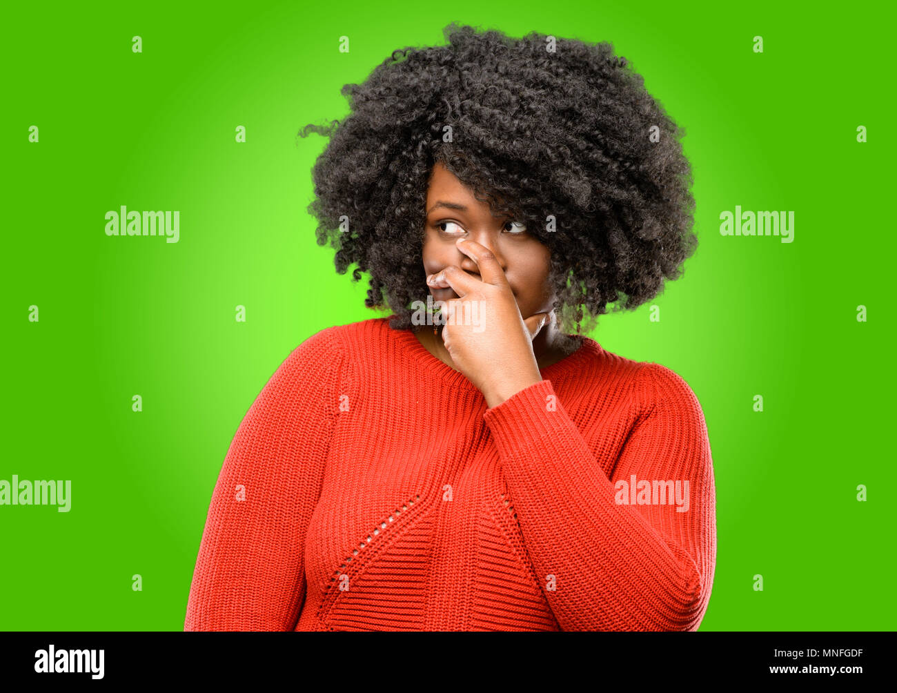 Beautiful african woman scared in shock, expressing panic and fear ...