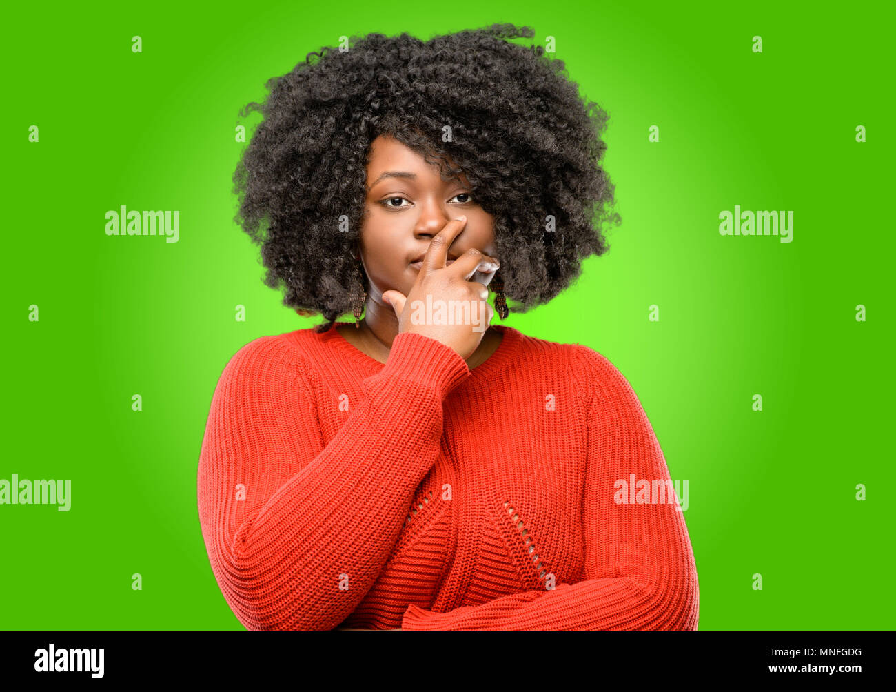 Beautiful african woman scared in shock, expressing panic and fear ...