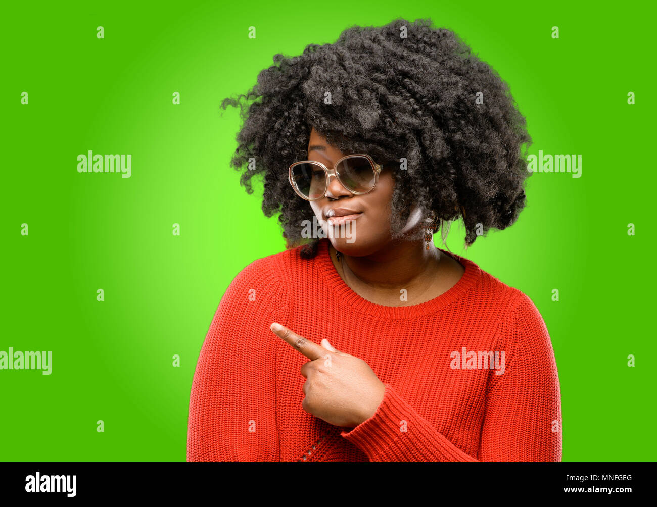 Beautiful african woman pointing away side with finger Stock Photo - Alamy