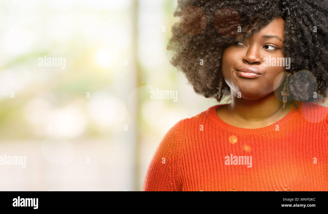 Beautiful african woman doubt expression, confuse and wonder concept ...