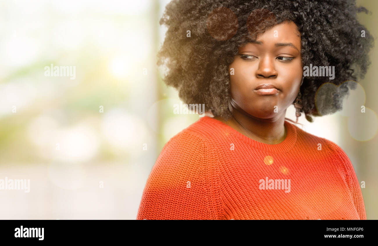 Beautiful african woman doubt expression, confuse and wonder concept ...