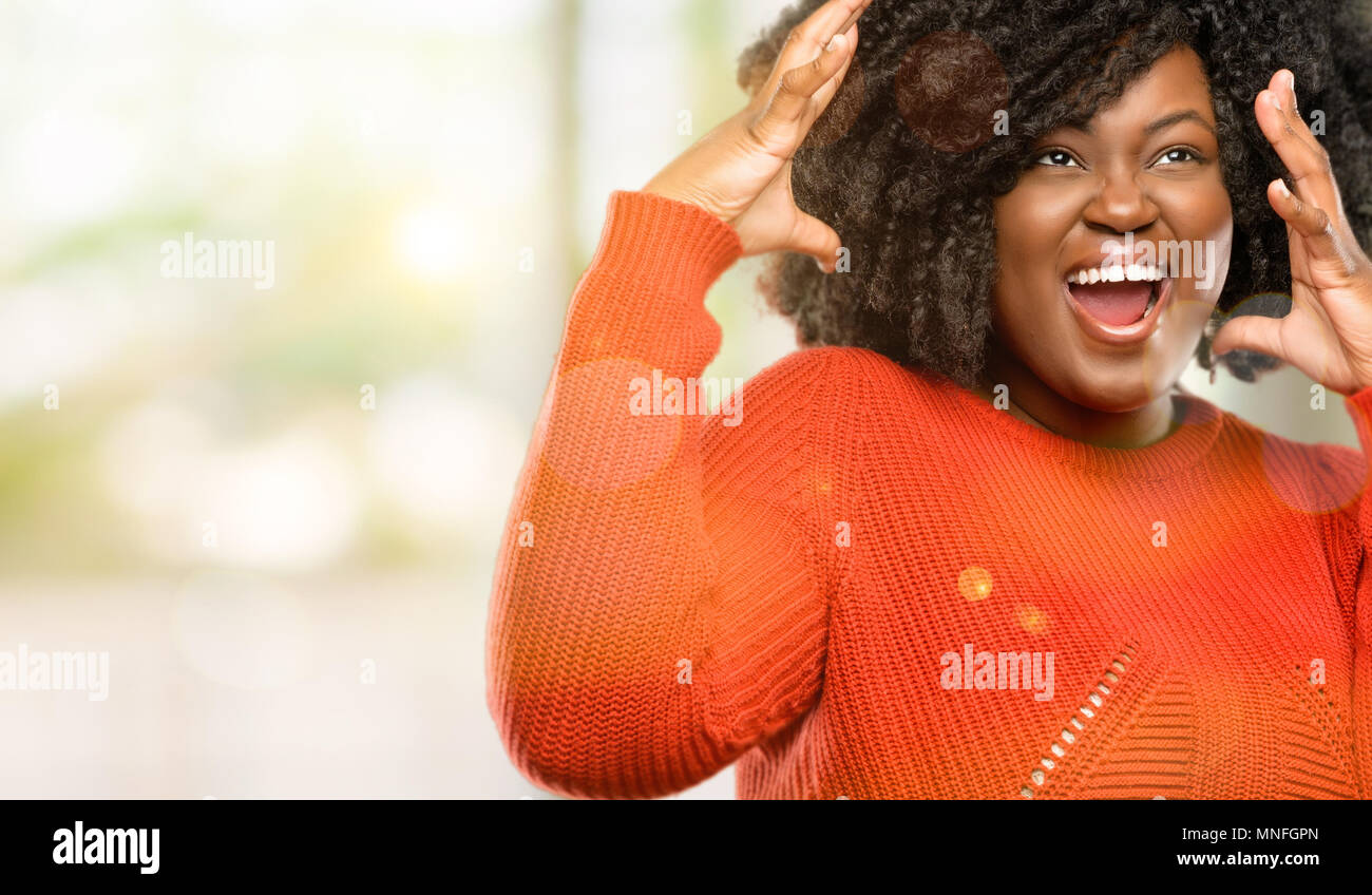 Beautiful african woman happy and surprised cheering expressing wow ...