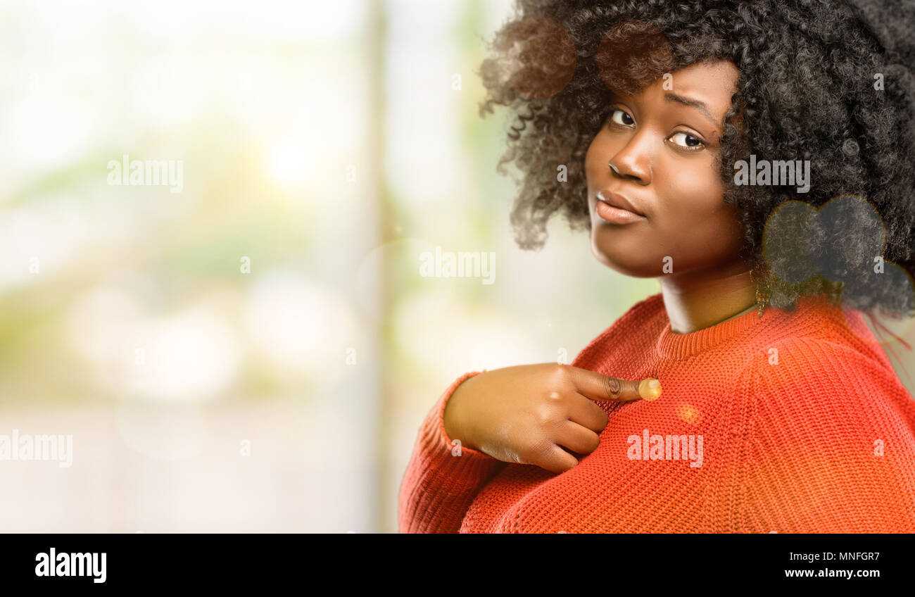 Beautiful african woman happy and surprised cheering expressing wow ...