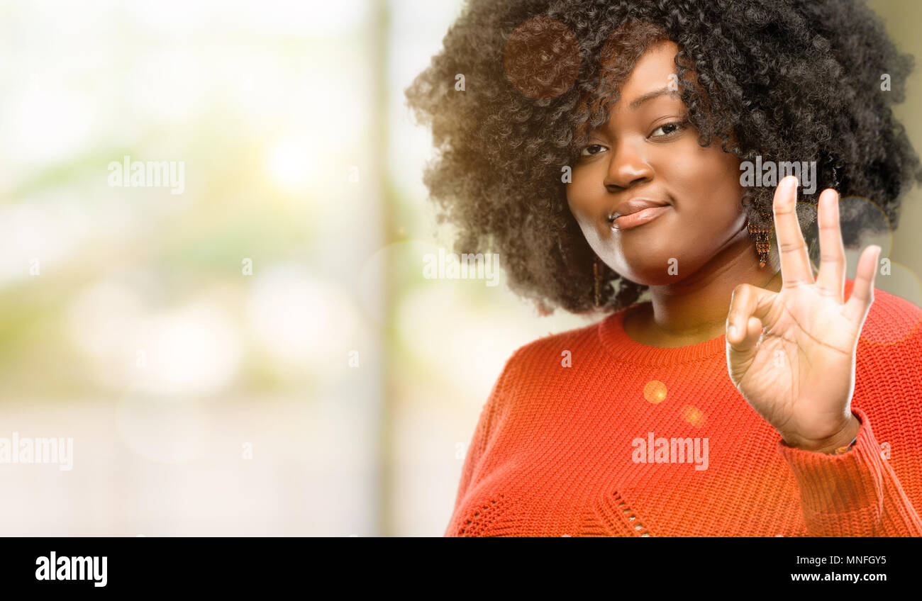 Beautiful african woman raising his finger, is the number three ...