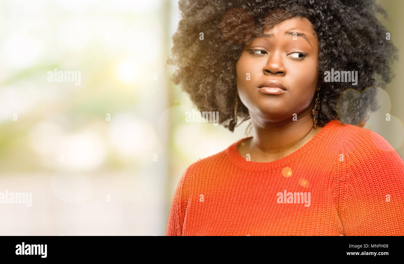 Curvy african american woman suspicious hi-res stock photography and ...