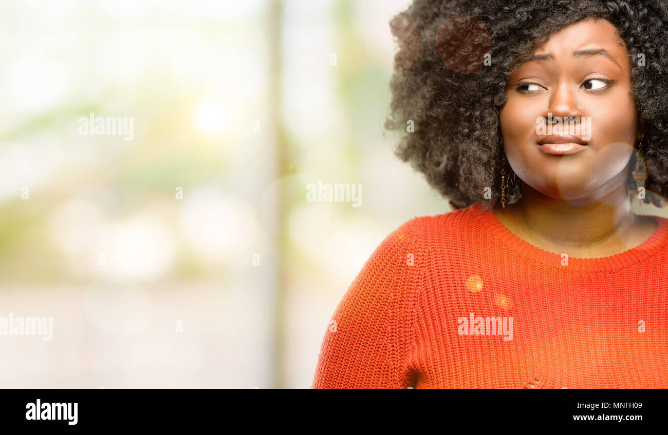 Beautiful african woman having skeptical and dissatisfied look ...