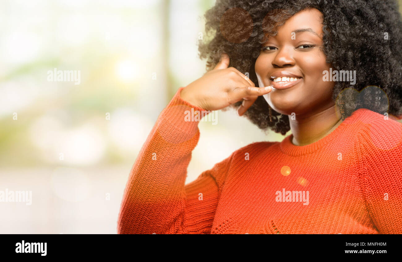 Beautiful african woman happy and excited making showing call me ...