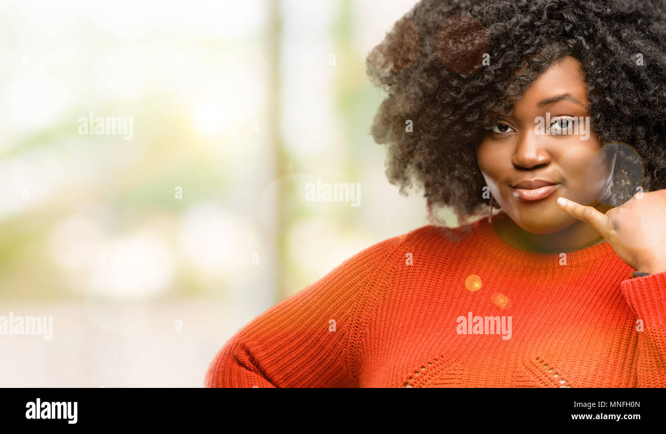 Beautiful african woman happy and excited making showing call me ...