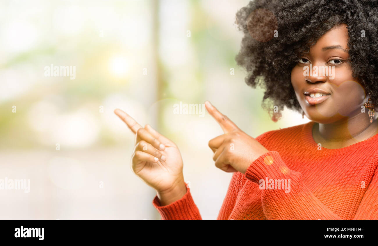 Beautiful african woman pointing away side with fingers, outdoor Stock ...