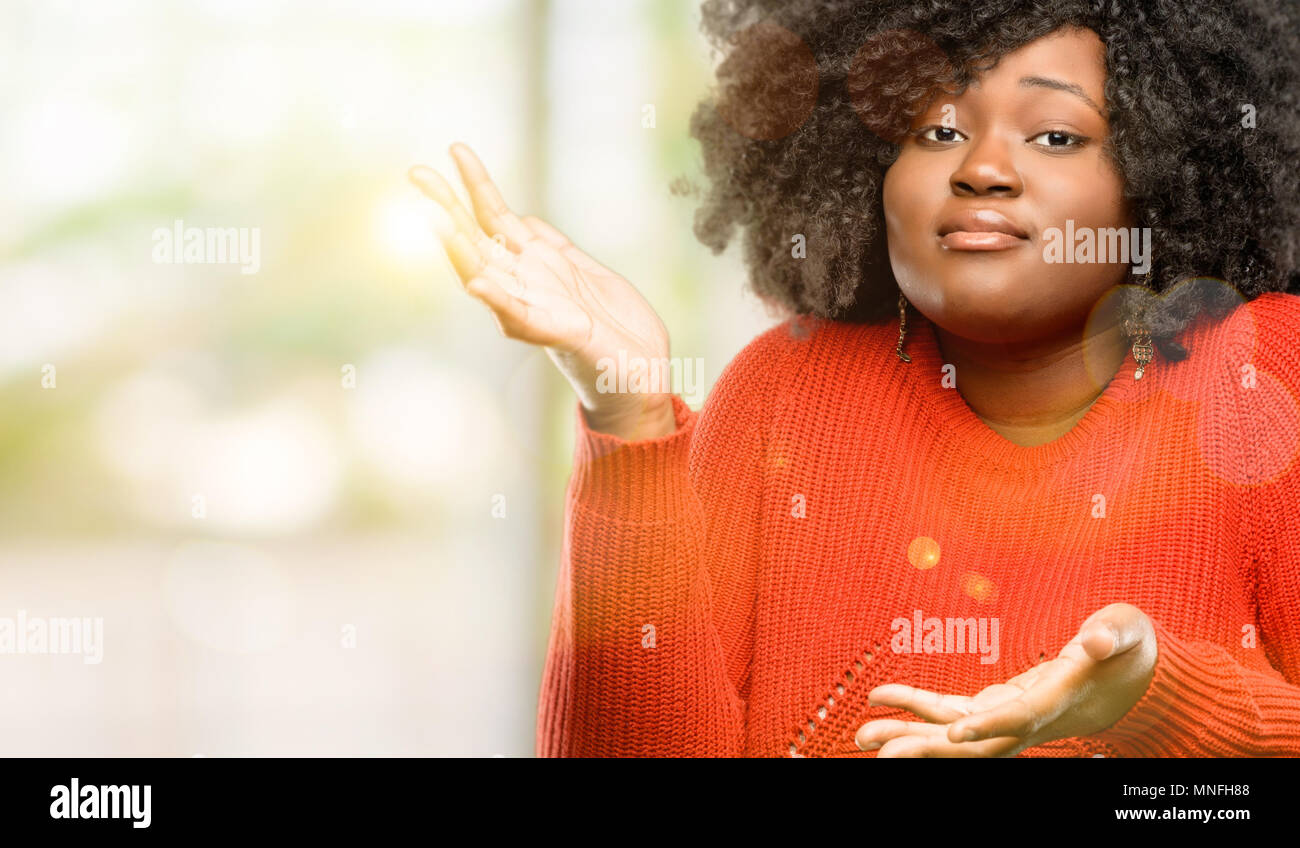 Beautiful african woman doubt expression, confuse and wonder concept ...