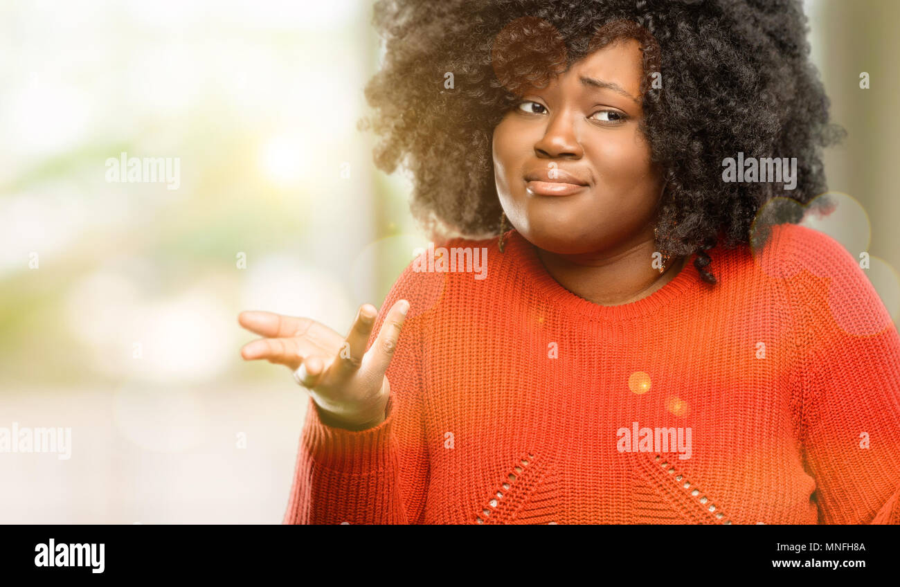 Beautiful african woman doubt expression, confuse and wonder concept ...