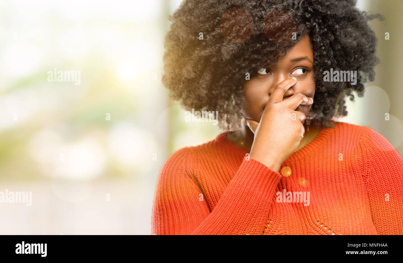 Beautiful african woman scared in shock, expressing panic and fear ...