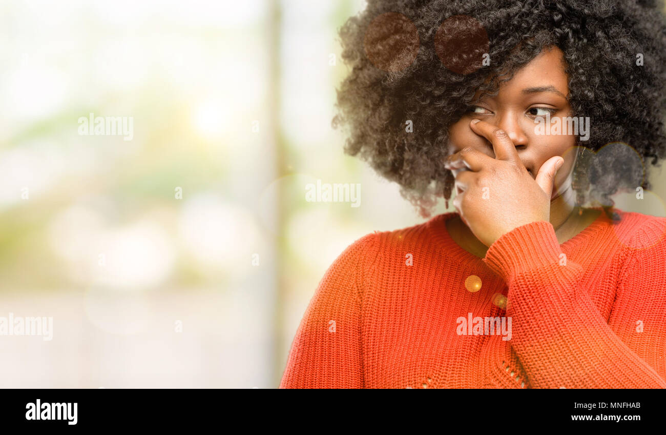 Beautiful african woman scared in shock, expressing panic and fear ...