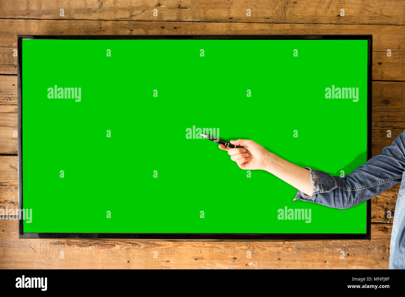 Blank TV screen for presentations. Woman's hand pointing to screen ...