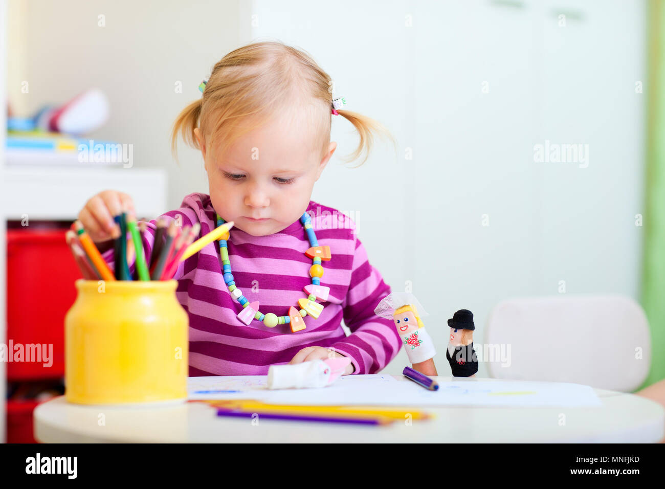 Portrait of adorable toddler girl coloring with pencils Stock Photo - Alamy