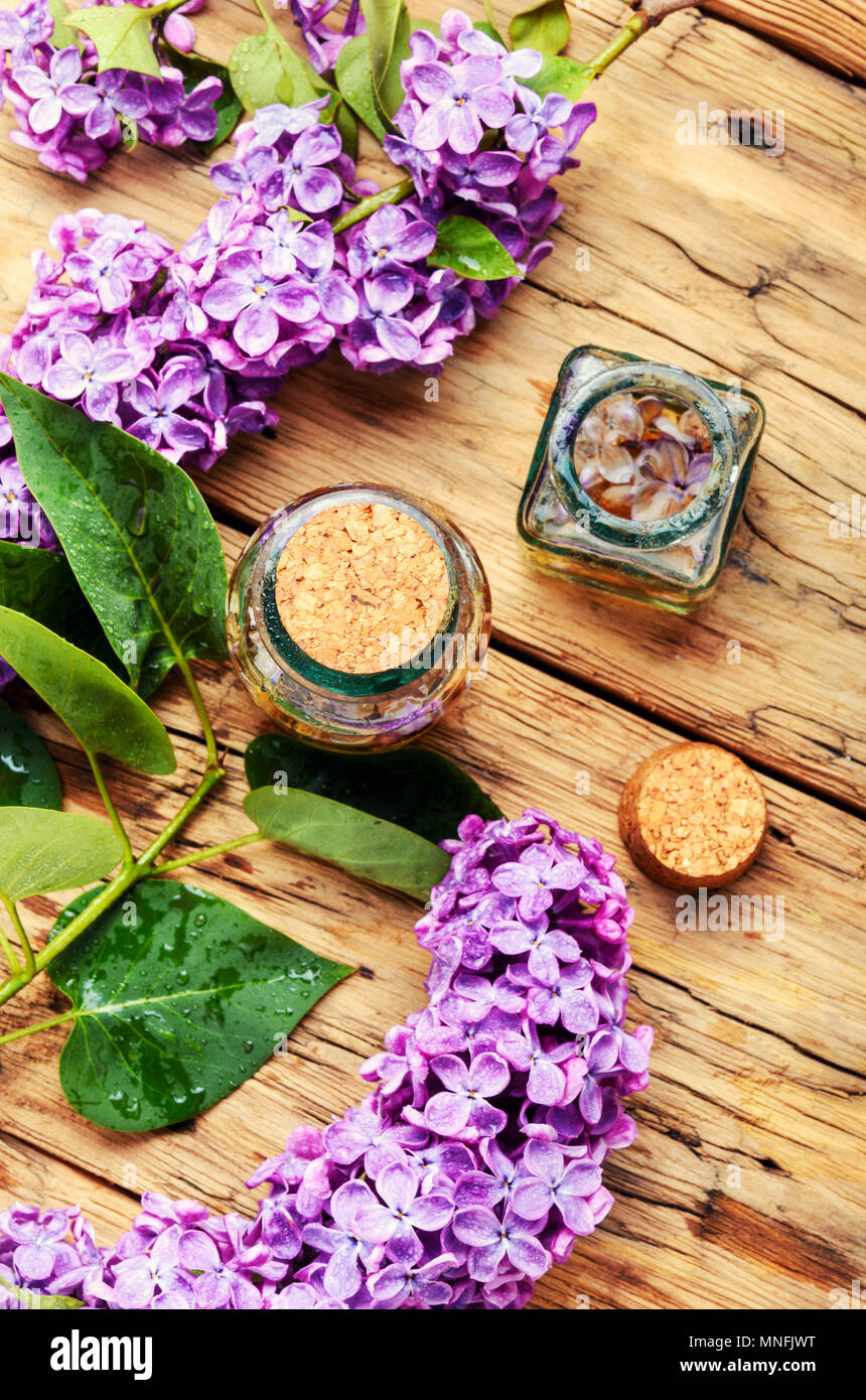 Bottle of essential extraction with lilac.Healing herbs.Alternative ...