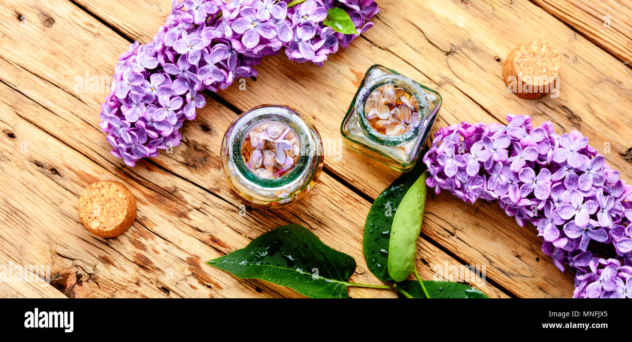 Bottle of essential extraction with lilac.Healing herbs.Alternative ...
