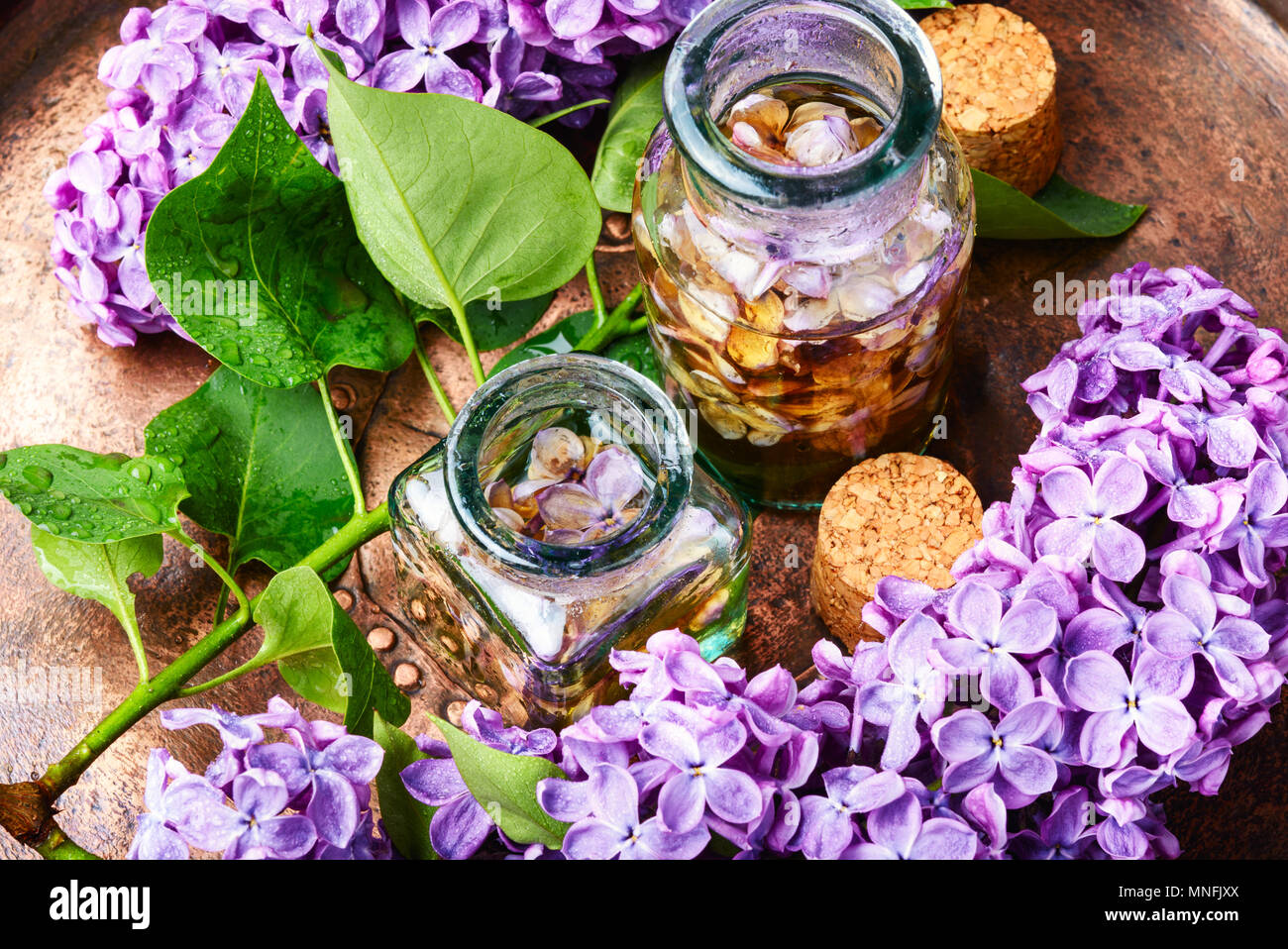 Bottle of essential extraction with lilac.Healing herbs.Alternative ...