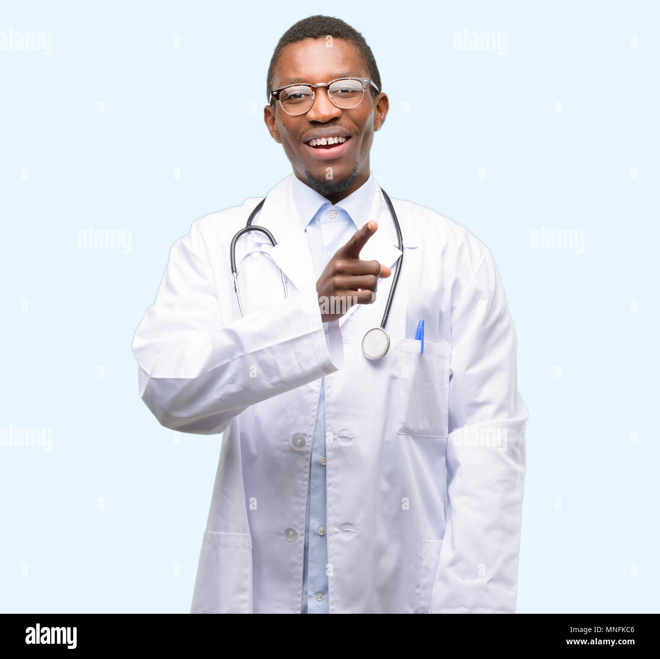 Young black doctor, medical professional pointing away side with finger ...