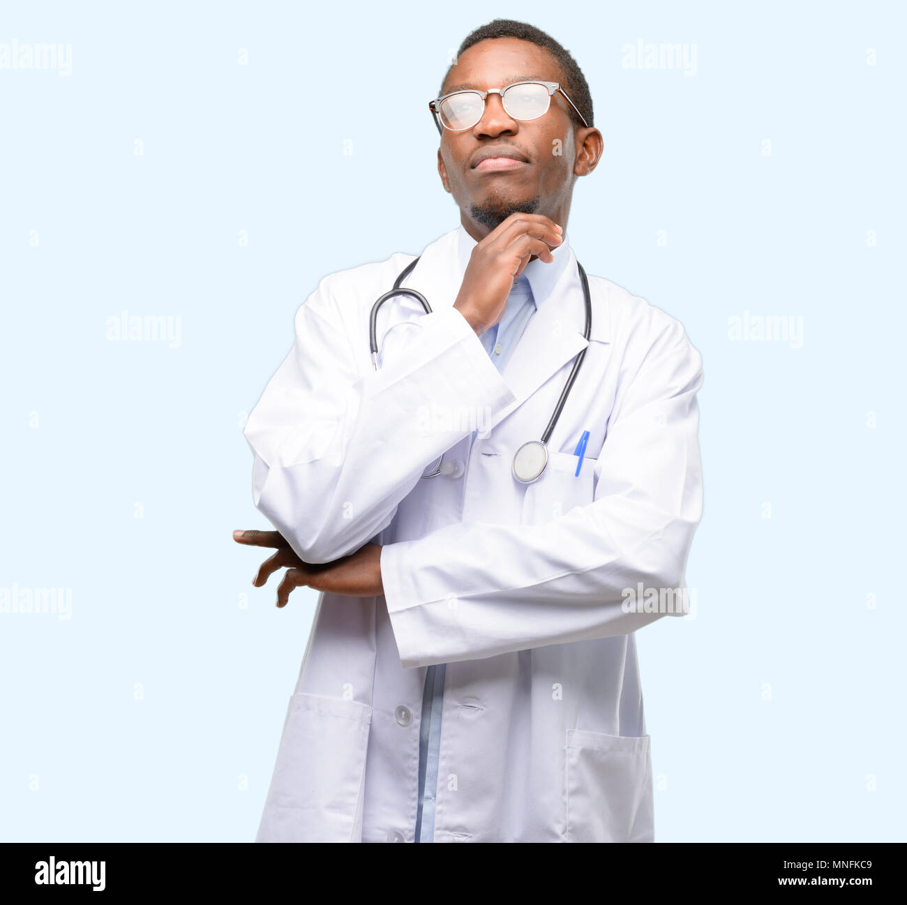 Young black doctor, medical professional thinking and looking up ...