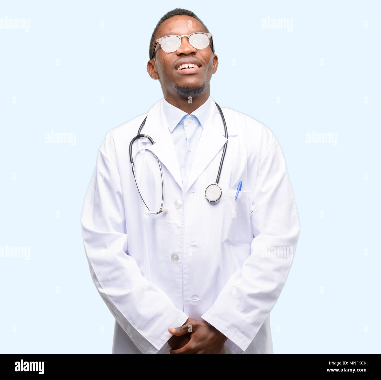 Young black doctor, medical professional thinking and looking up ...
