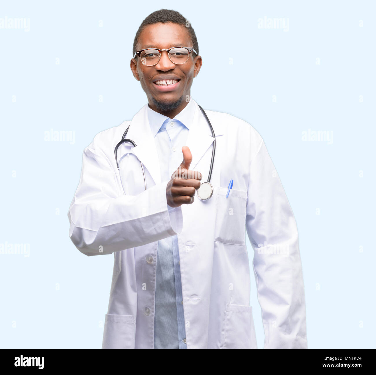 Young black doctor, medical professional smiling broadly showing thumbs ...