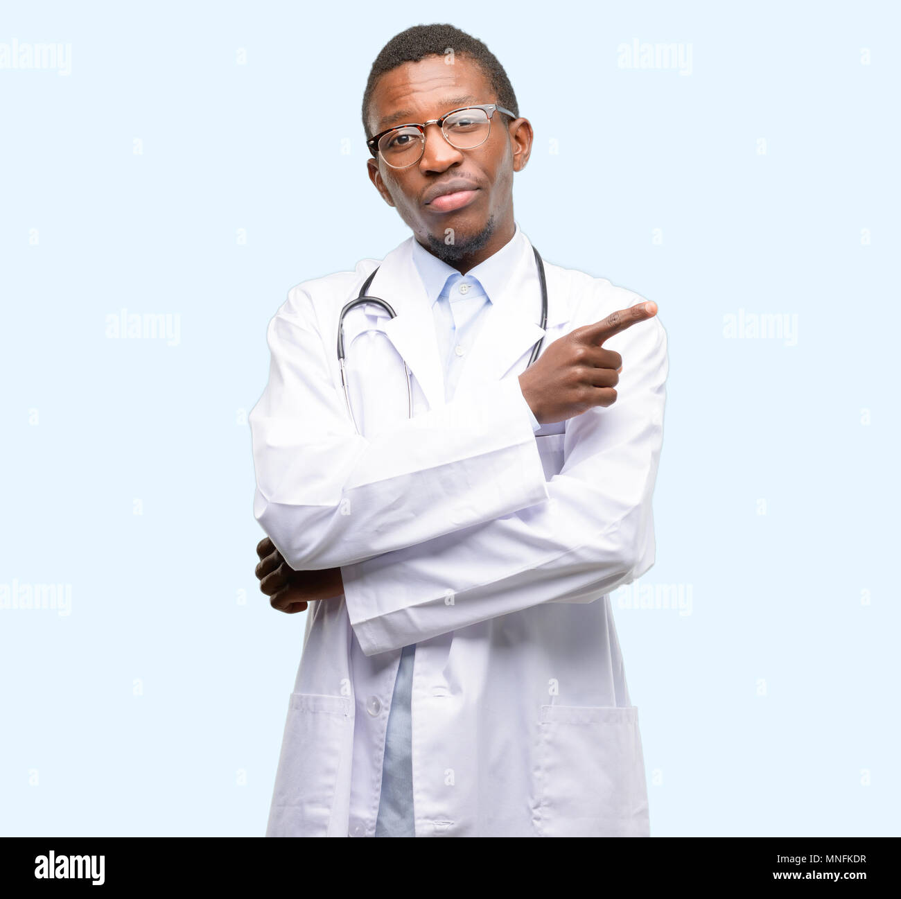 Young black doctor, medical professional pointing away side with finger ...